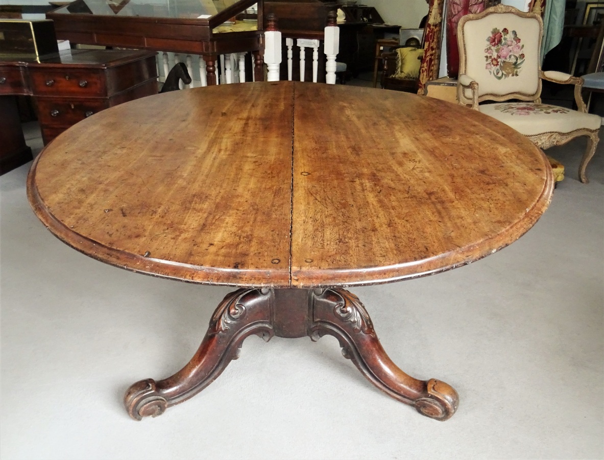 An Early Victorian Period Walnut Oval Pedestal Dining Table